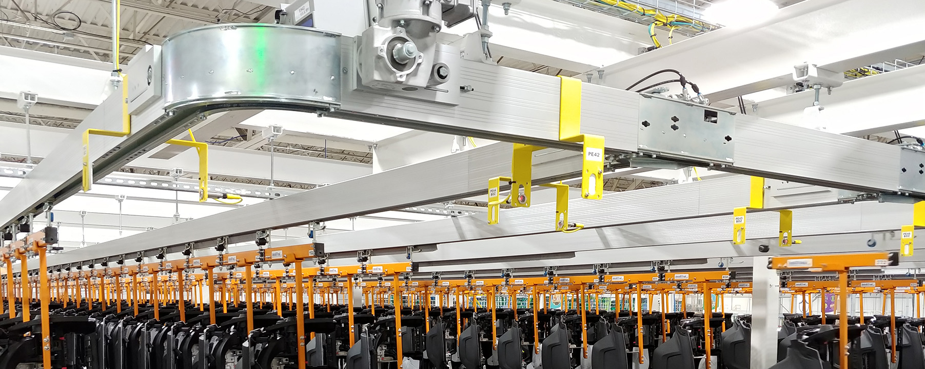 Overhead conveyors for flexible pickup, storage and production solutions